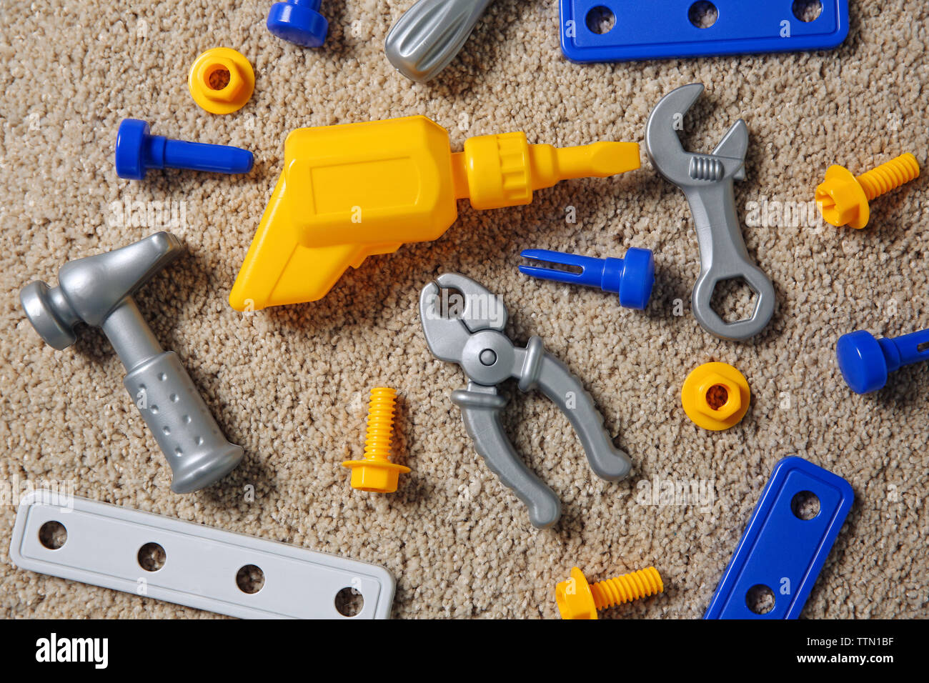 Set of plastic children toys on carpet, top view Stock Photo - Alamy