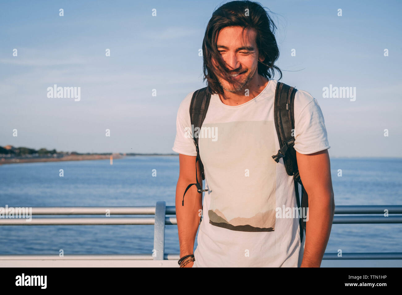 Brazilian laughing on a pier at the sunset with sea views Stock Photo ...