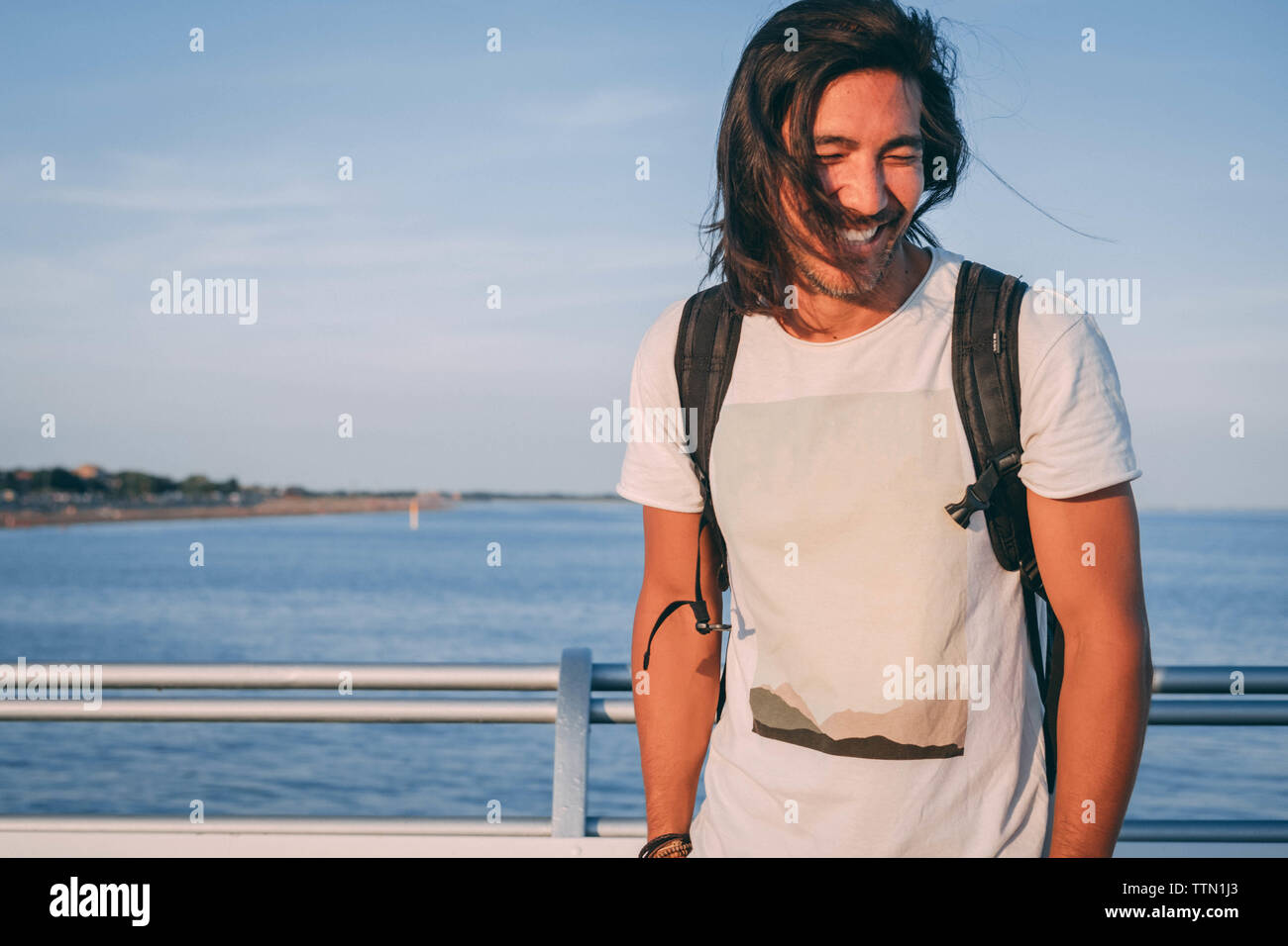Brazilian laughing on a pier at the sunset with sea views Stock Photo ...