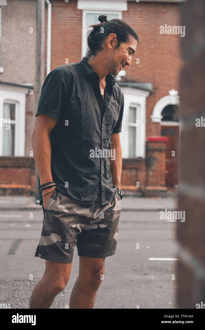 Person smiling while walking on street in England Stock Photo - Alamy