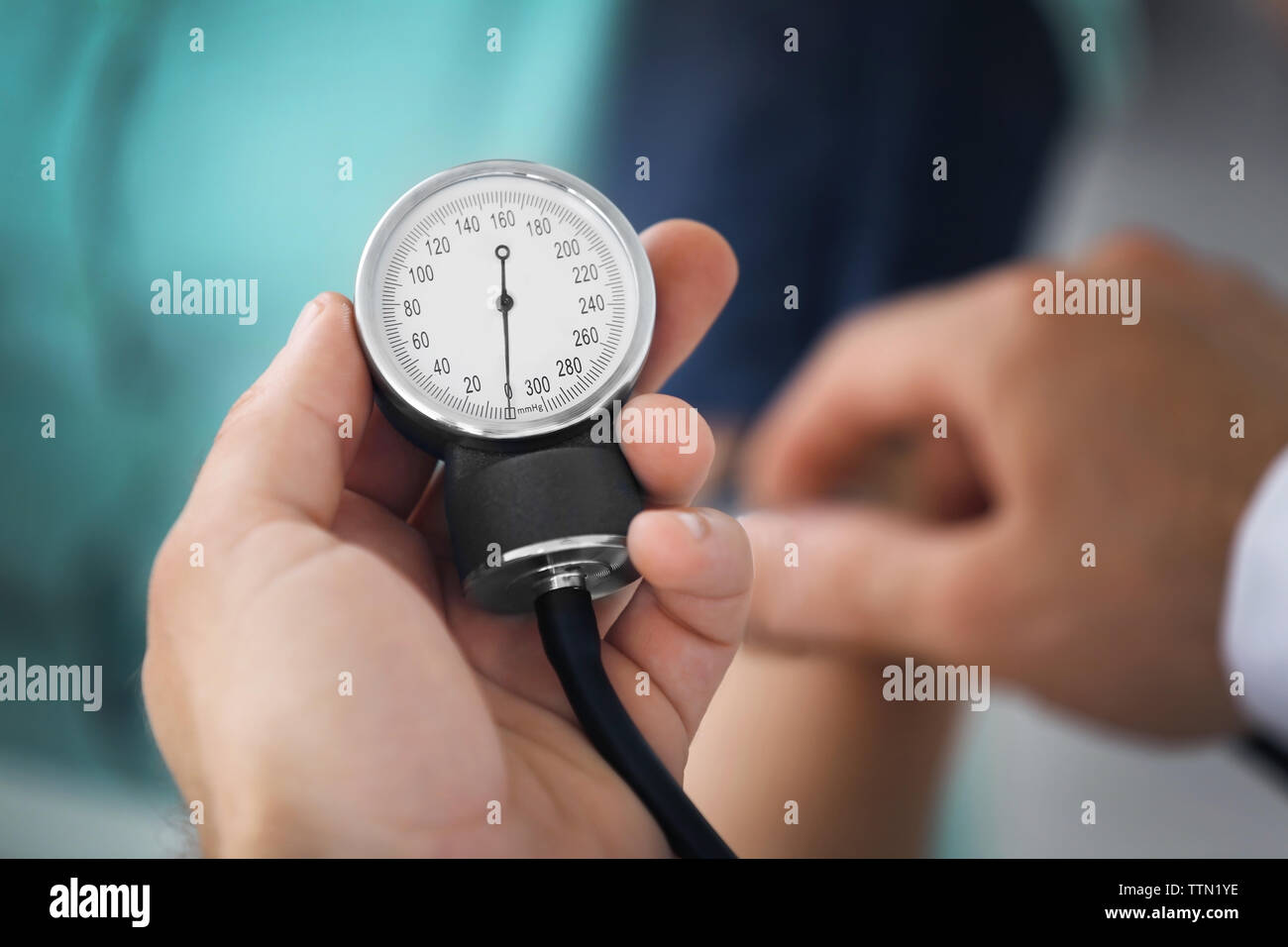 Male hand holding medical manometer and measuring blood pressure Stock ...