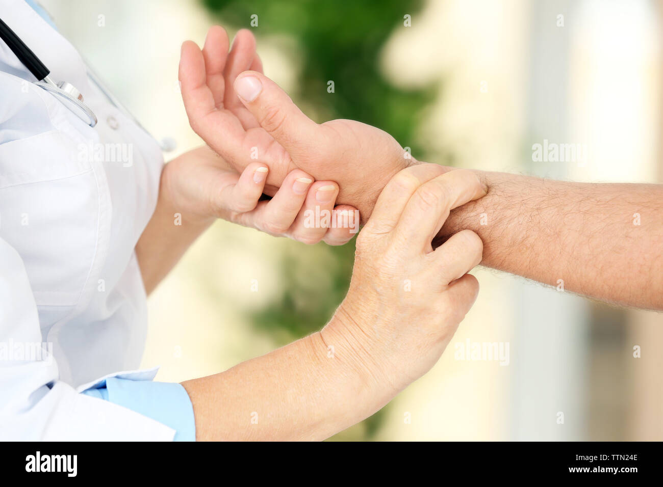 Female doctor measuring man pulse Stock Photo - Alamy