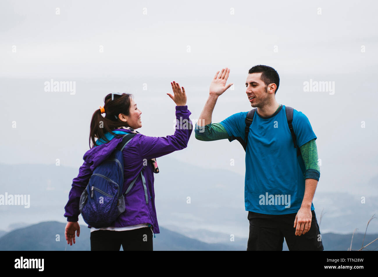 Asian man woman giving high hi-res stock photography and images - Alamy