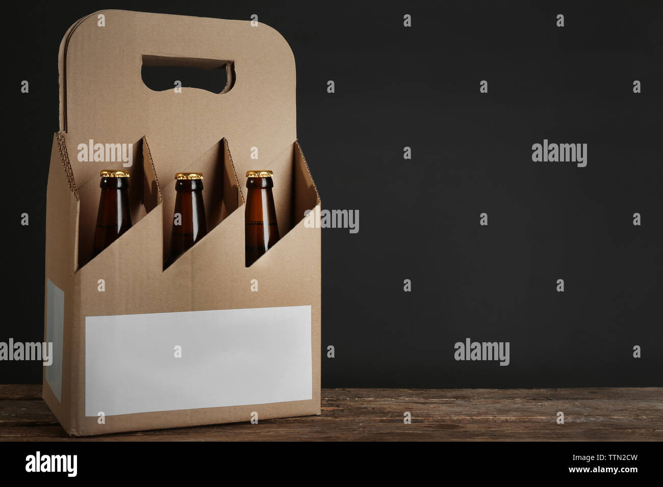 Paper beer package on black background Stock Photo - Alamy