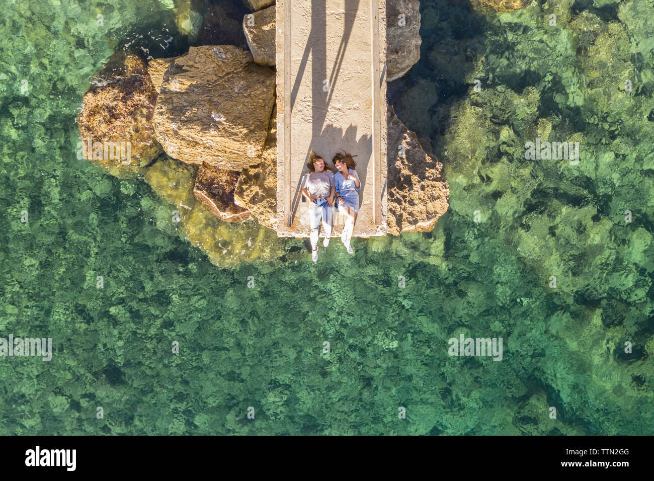 Girl lying on rocks hi-res stock photography and images - Alamy