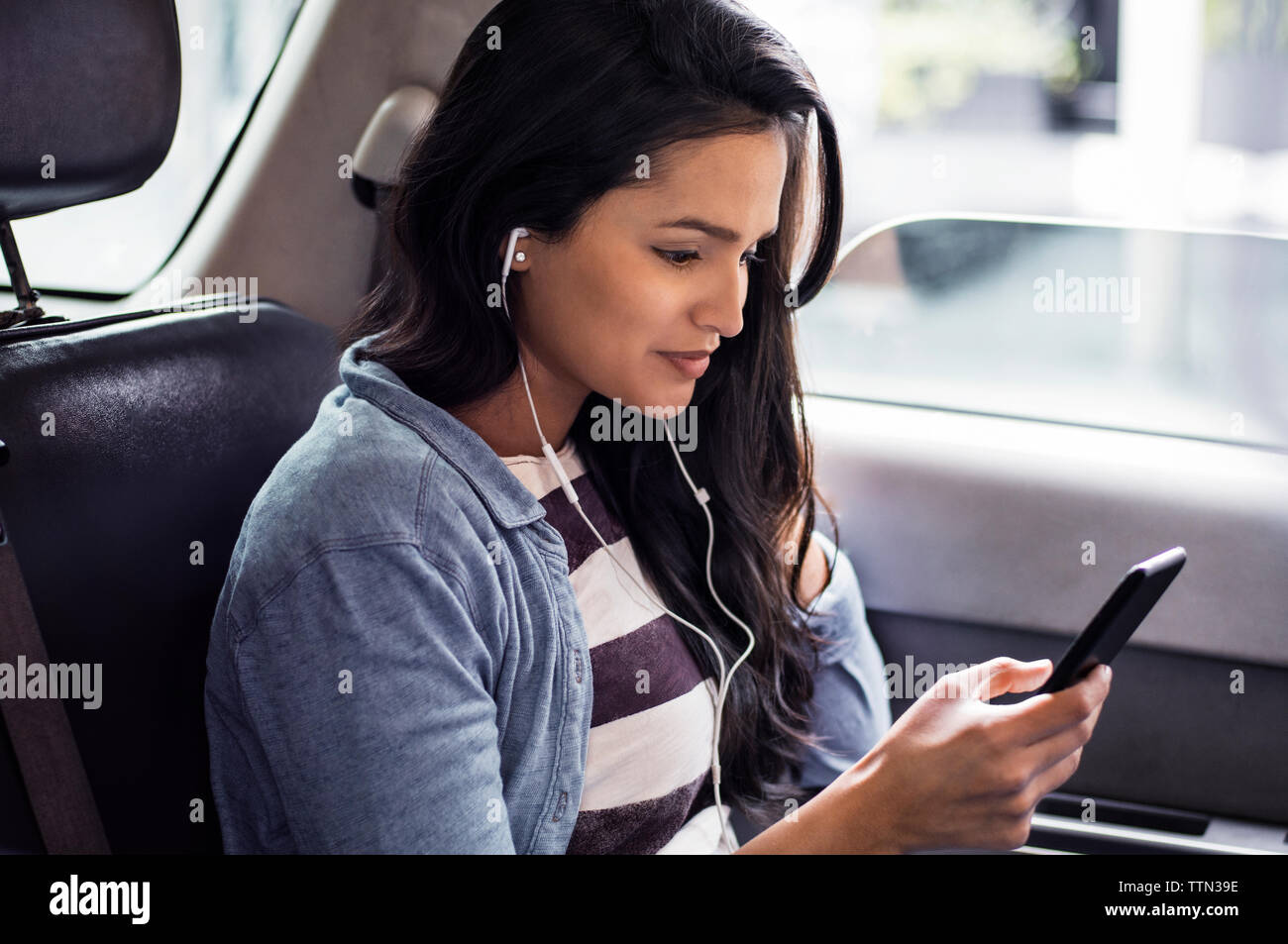 Woman texting in car hi-res stock photography and images - Alamy
