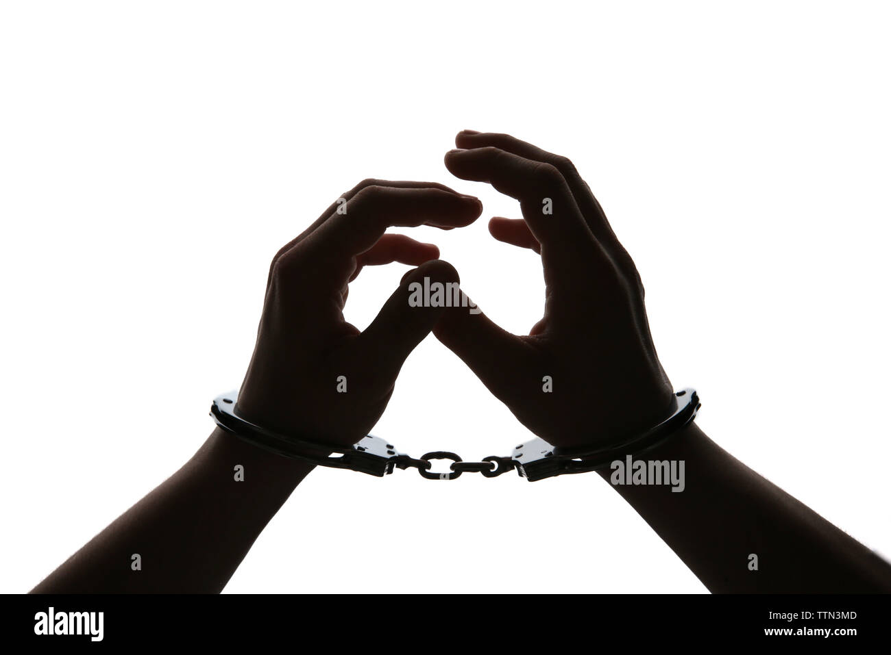 Black silhouette of man hands in handcuffs on light background Stock ...