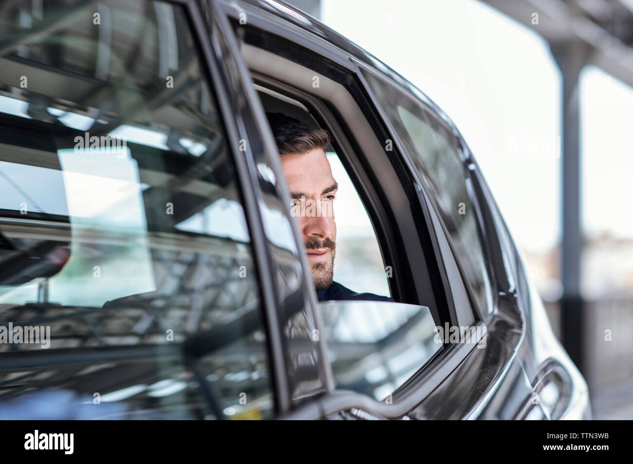 businessman looking through car window Stock Photo - Alamy