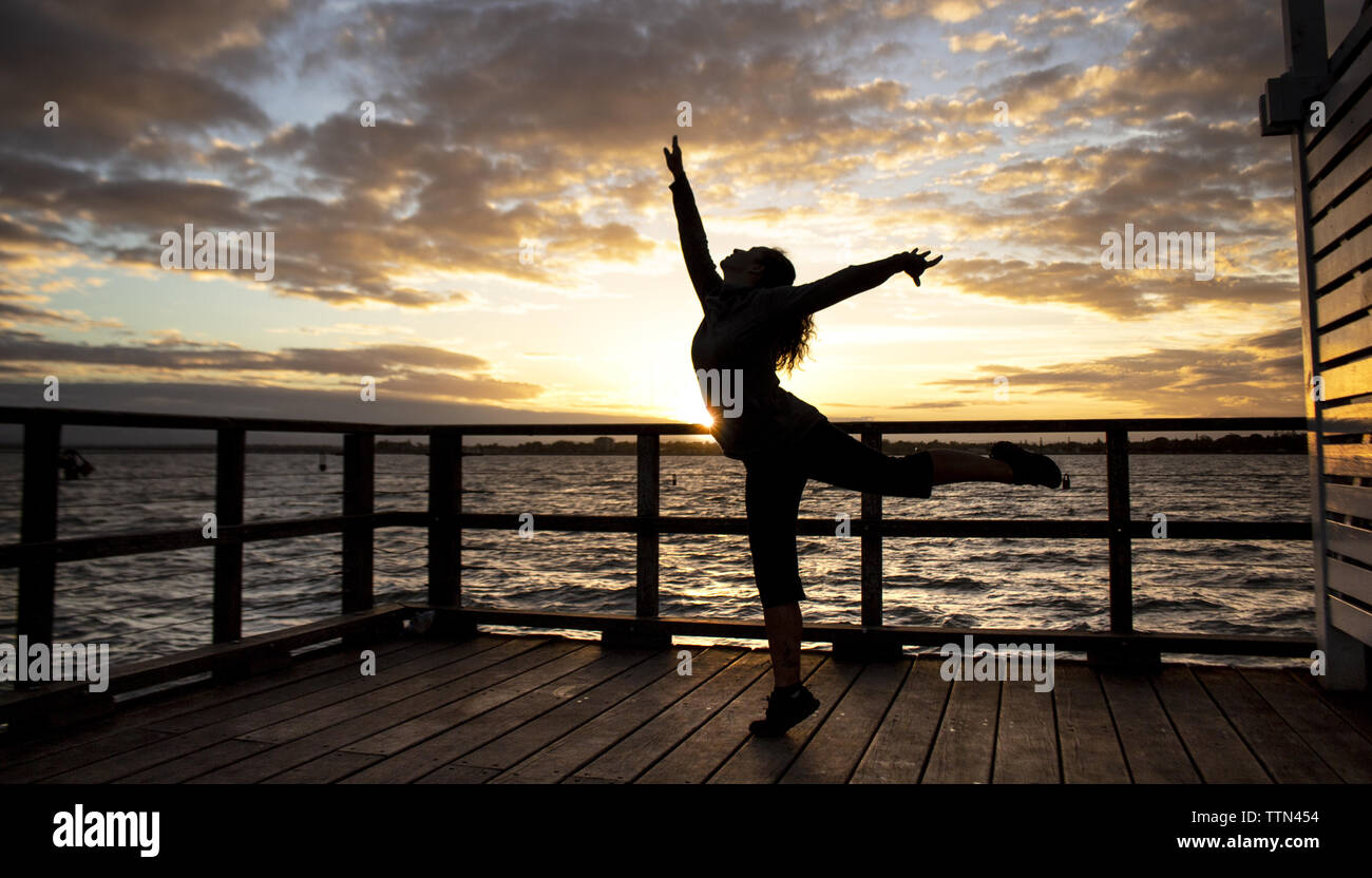 Girl dancing in front of sunset feel free Stock Photo - Alamy