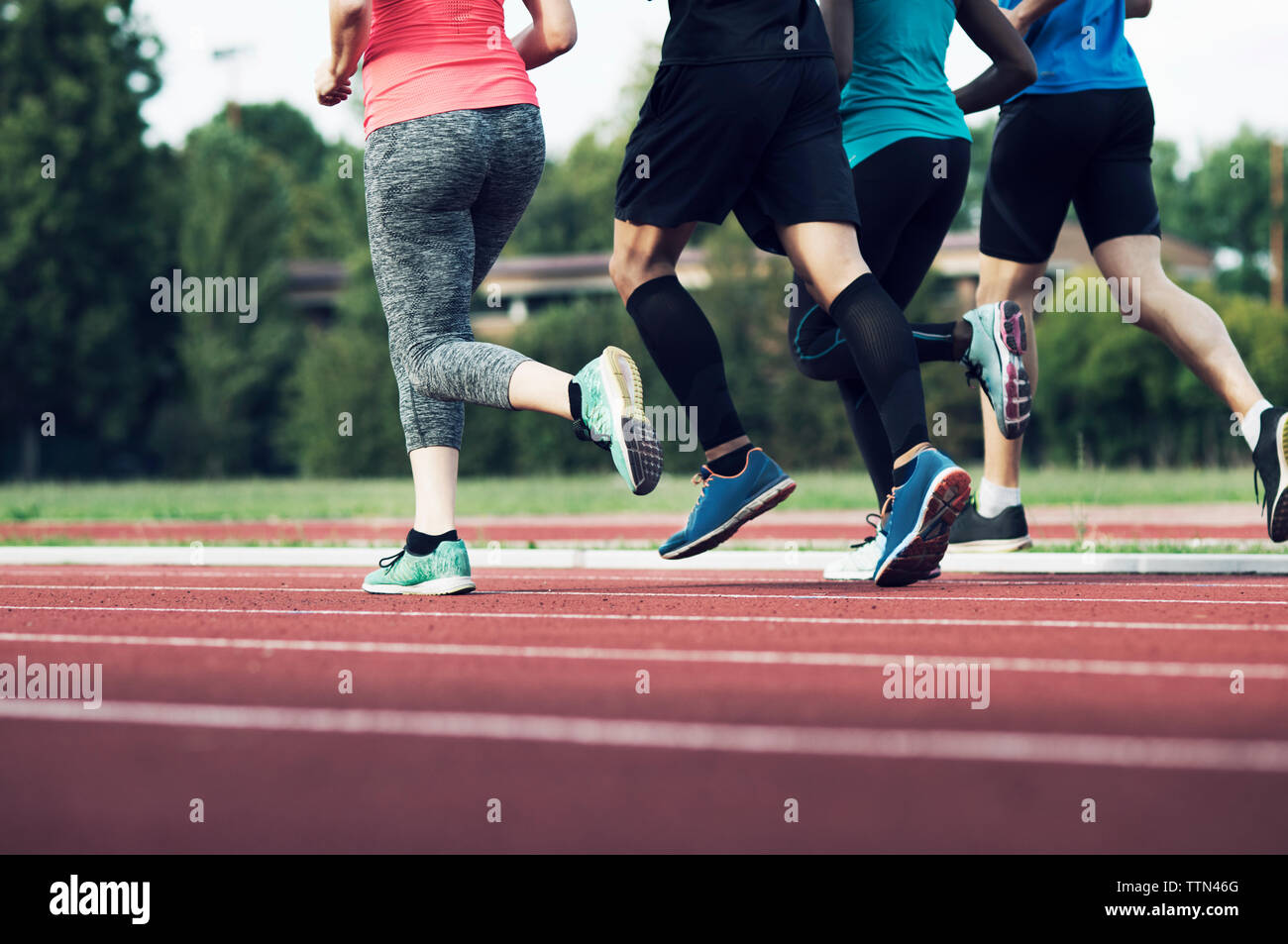 Runners on track side view hi-res stock photography and images - Alamy