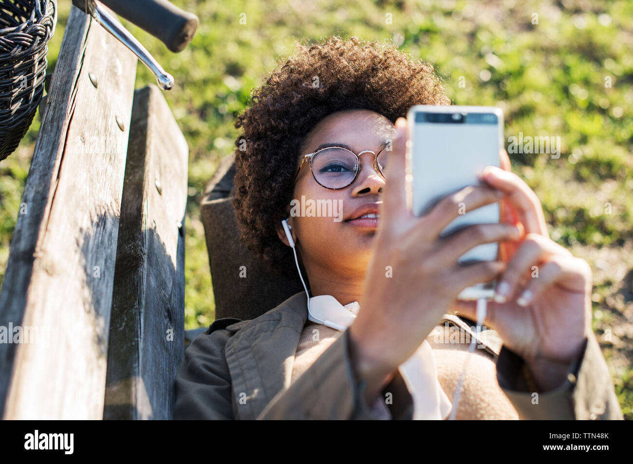 Young woman lying on bench hi-res stock photography and images - Alamy