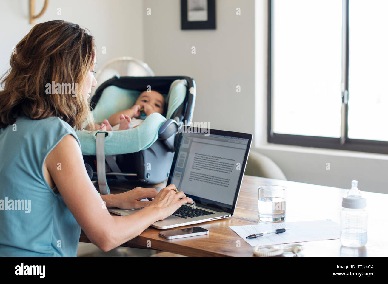 Boy sitting typing laptop home hi-res stock photography and images - Alamy