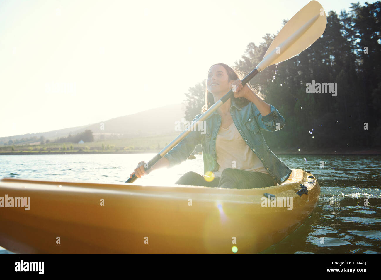 Smiling woman holding paddle hi-res stock photography and images - Alamy