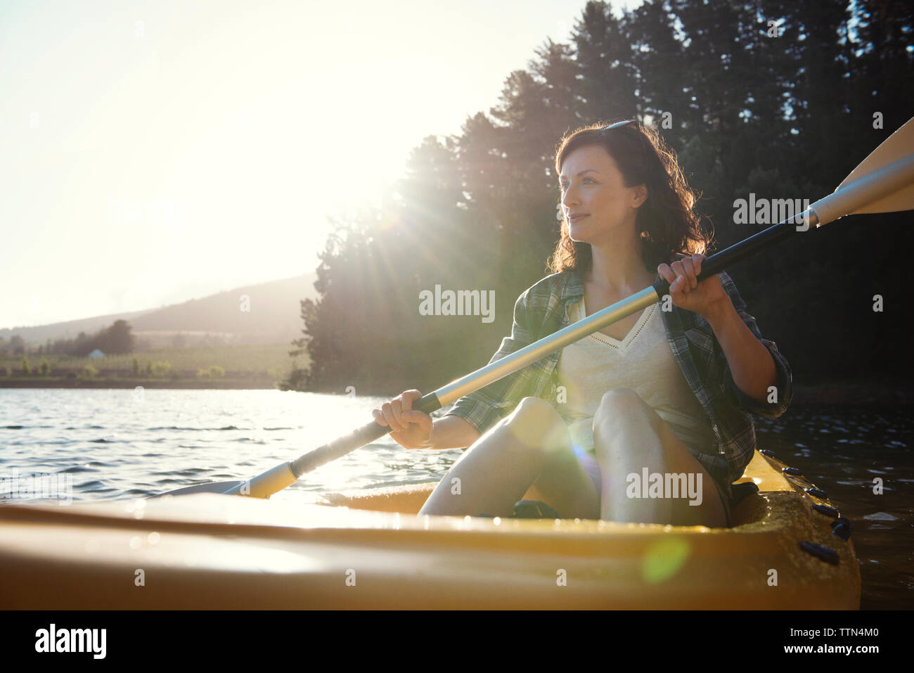 Smiling woman holding paddle hi-res stock photography and images - Alamy