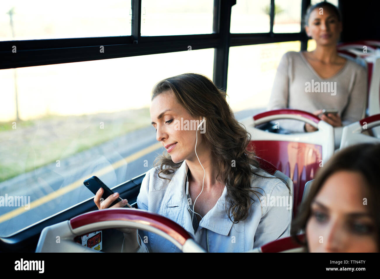 Female passengers traveling in tour bus Stock Photo - Alamy