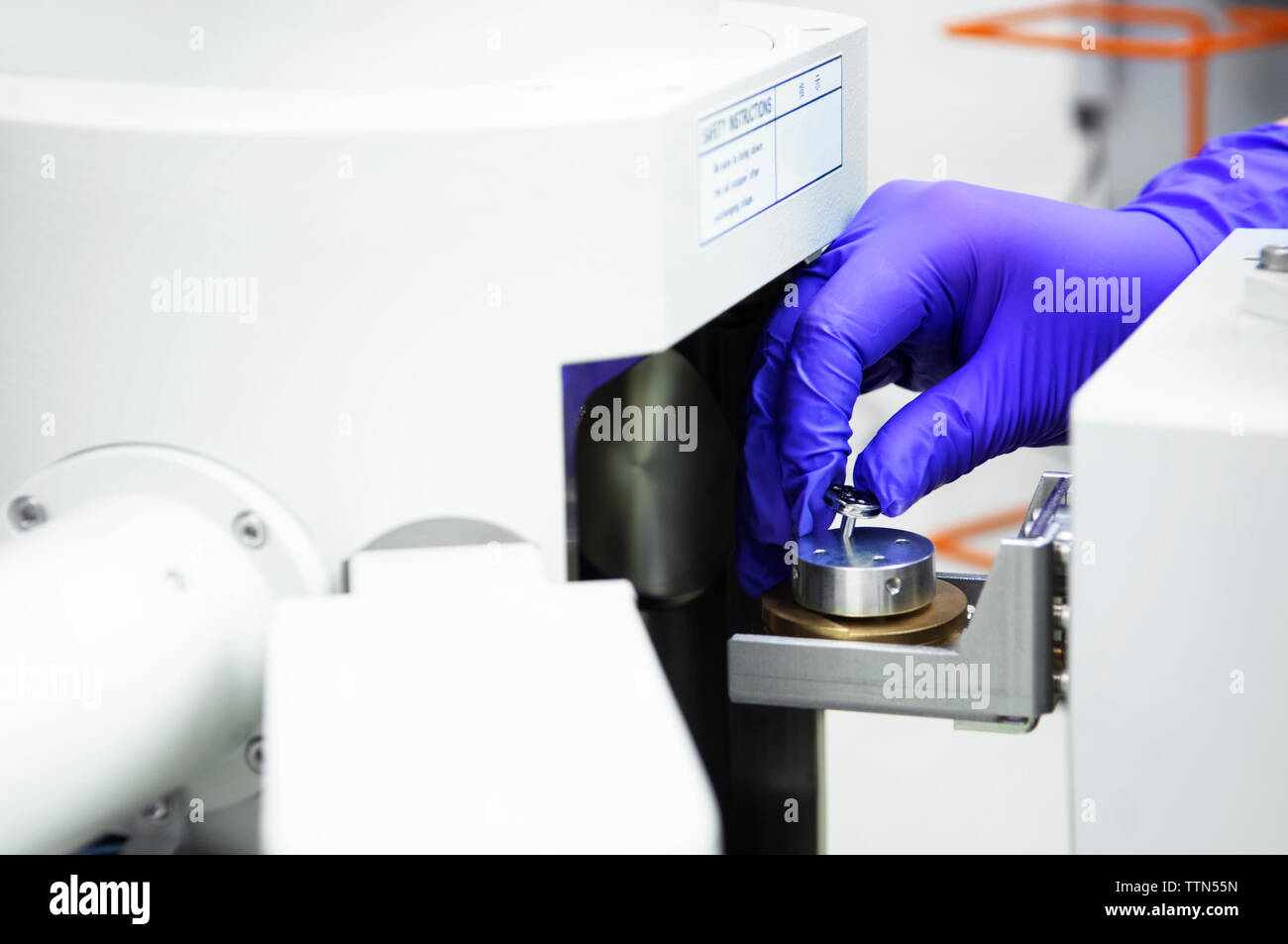 Technician using machinery in laboratory Stock Photo - Alamy