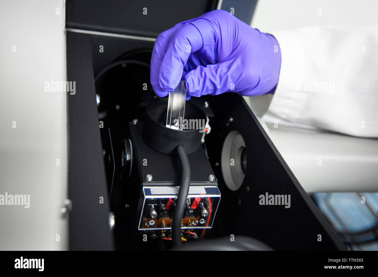 Technician using machinery in laboratory Stock Photo - Alamy