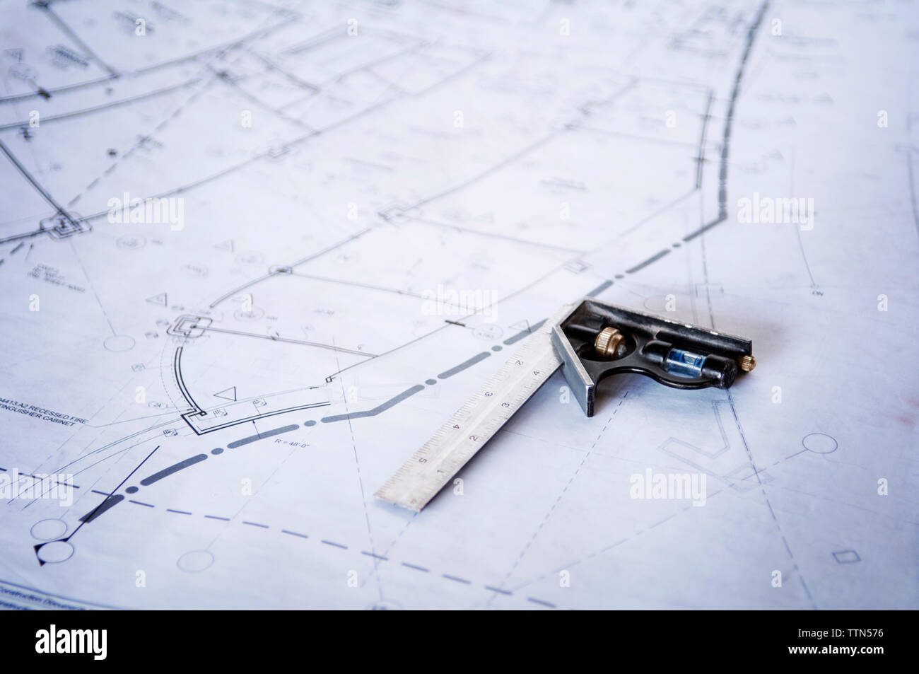 High angle view of measuring equipment on blueprint at construction ...