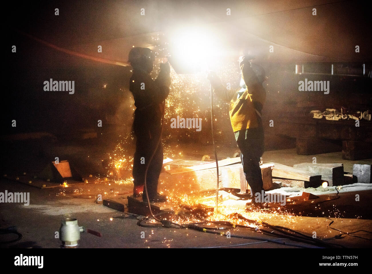 workers welding airplane wing at industry during night Stock Photo - Alamy