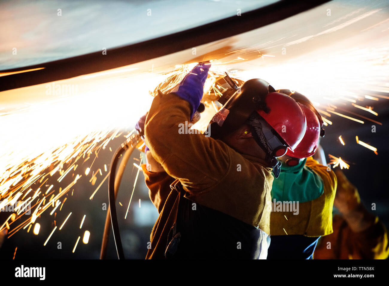 workers welding airplane wing at industry during night Stock Photo - Alamy