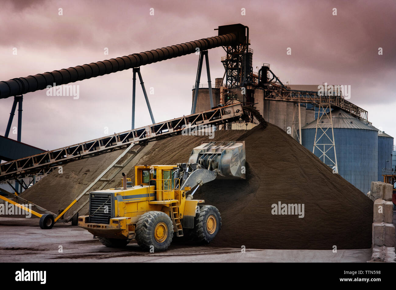 Excavator at cement factory Stock Photo - Alamy