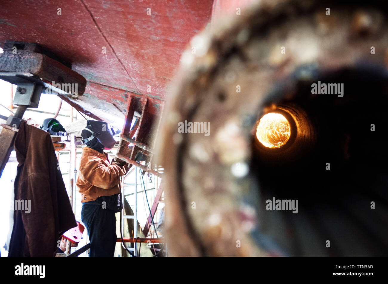 Side view of construction worker welding ship at industry Stock Photo ...
