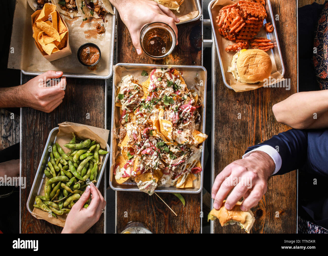 Friends eating chips hi-res stock photography and images - Alamy