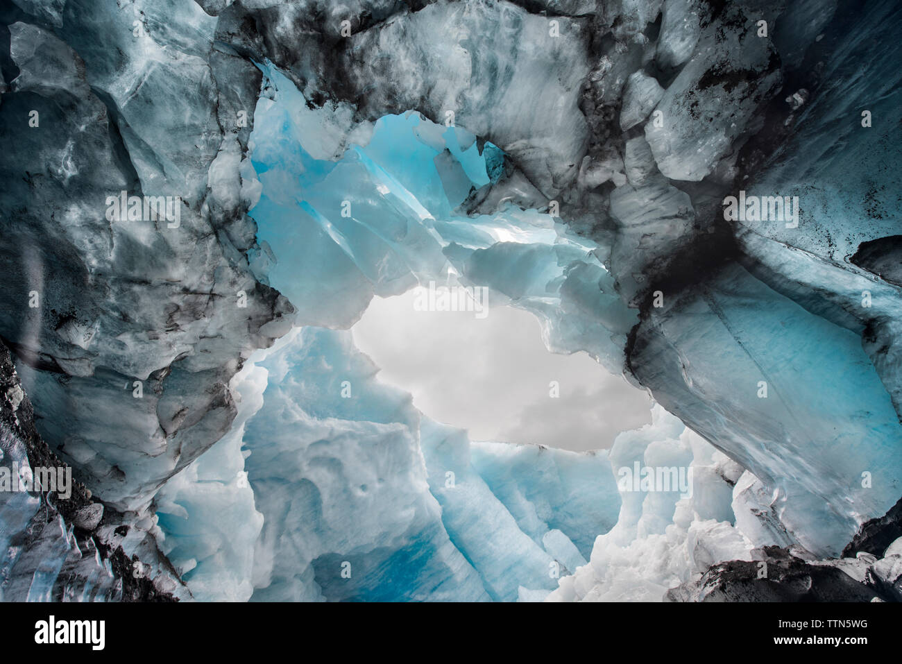 Sky seen through ice formation Stock Photo - Alamy