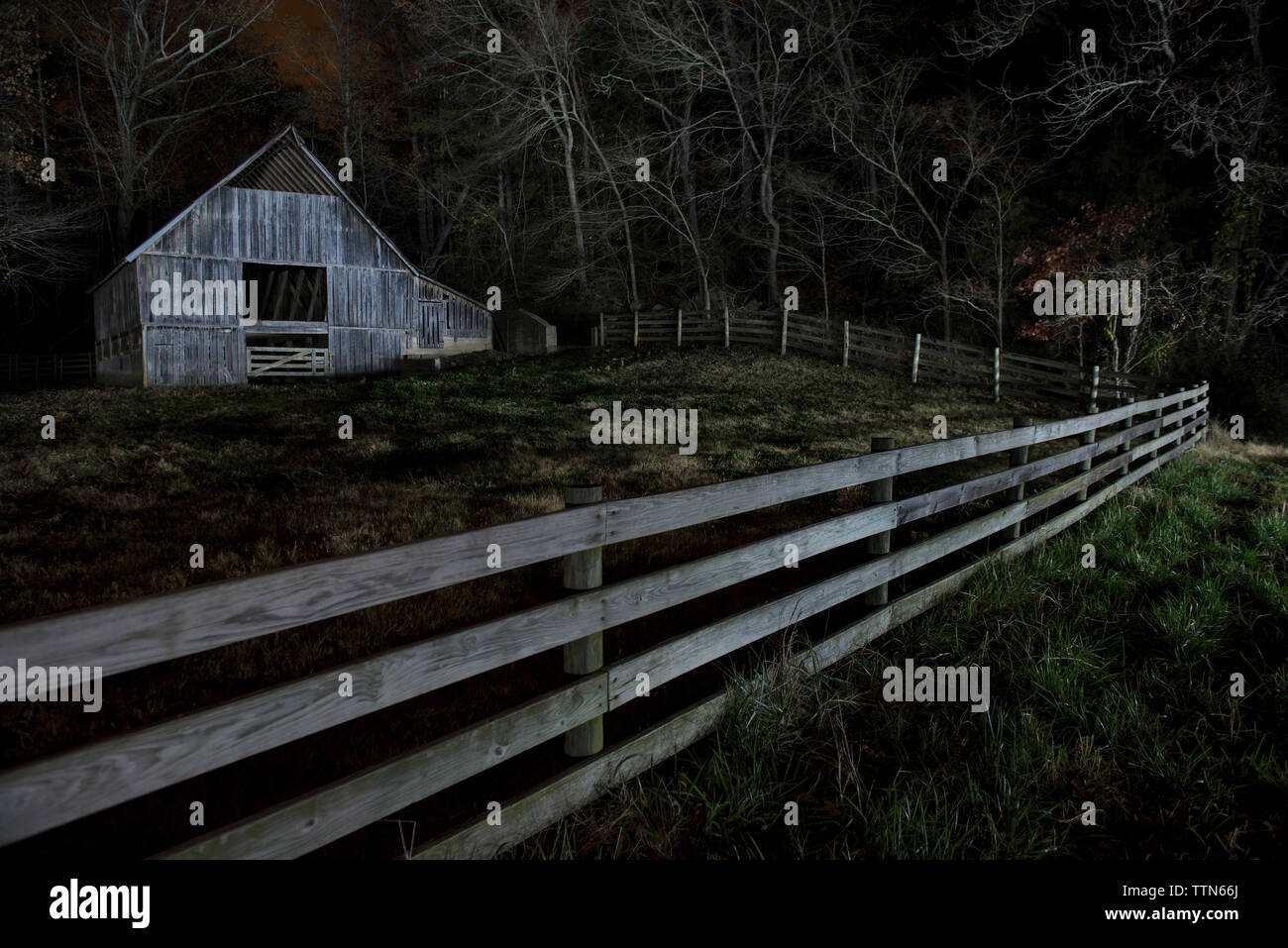 Old barn on field in forest at night Stock Photo - Alamy