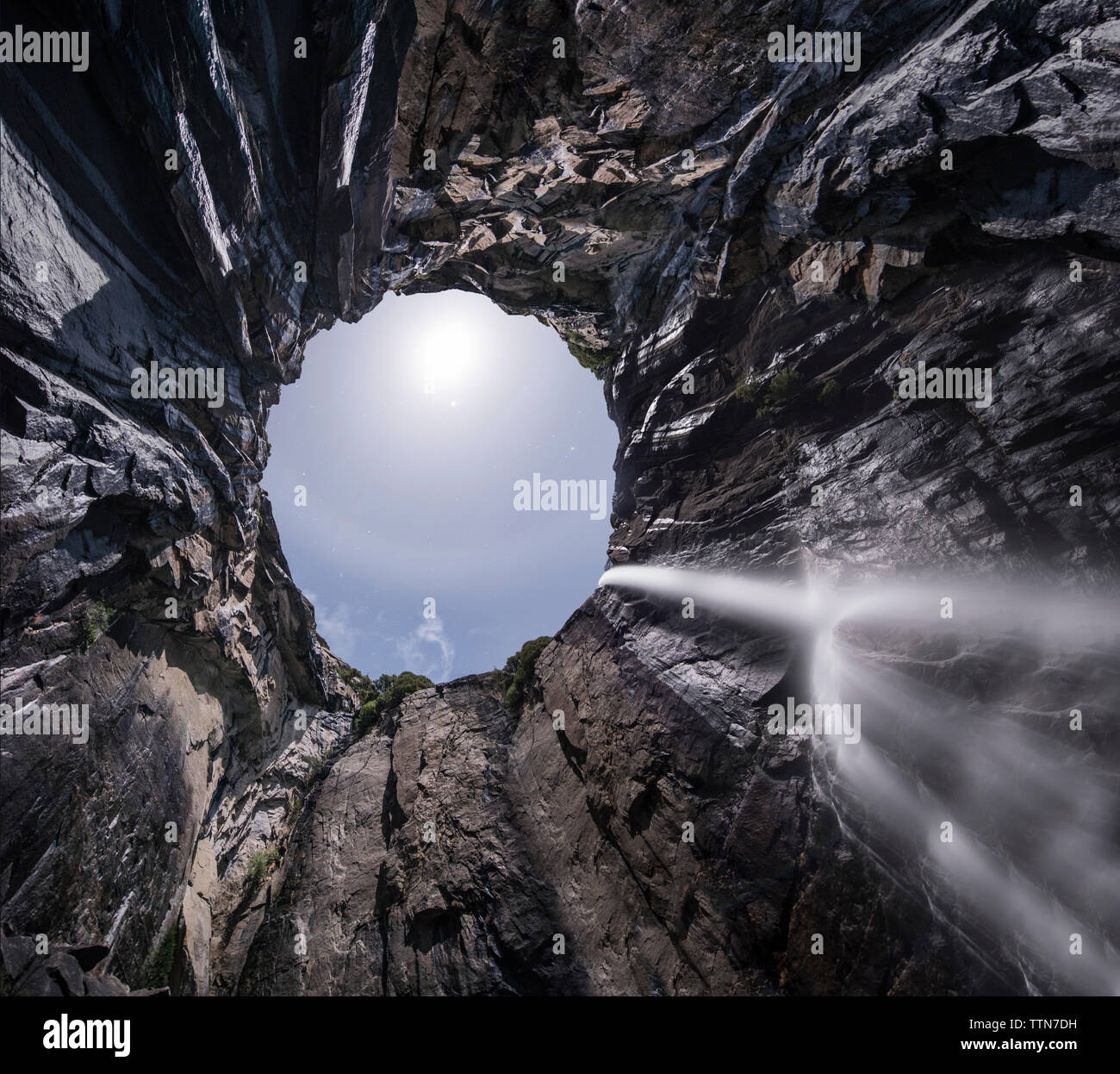 Low angle view of waterfall at cliff against sky Stock Photo - Alamy
