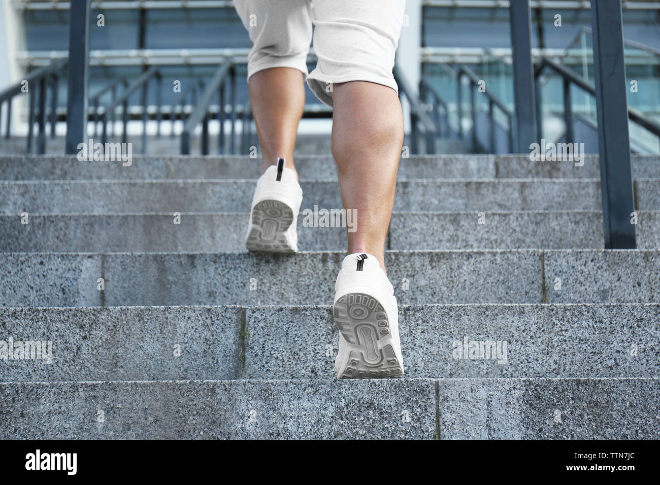 Young man running on stairs Stock Photo - Alamy