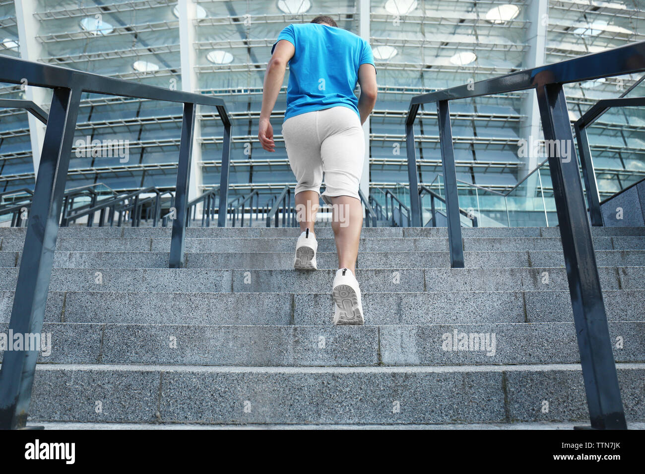 Young man running on stairs Stock Photo - Alamy
