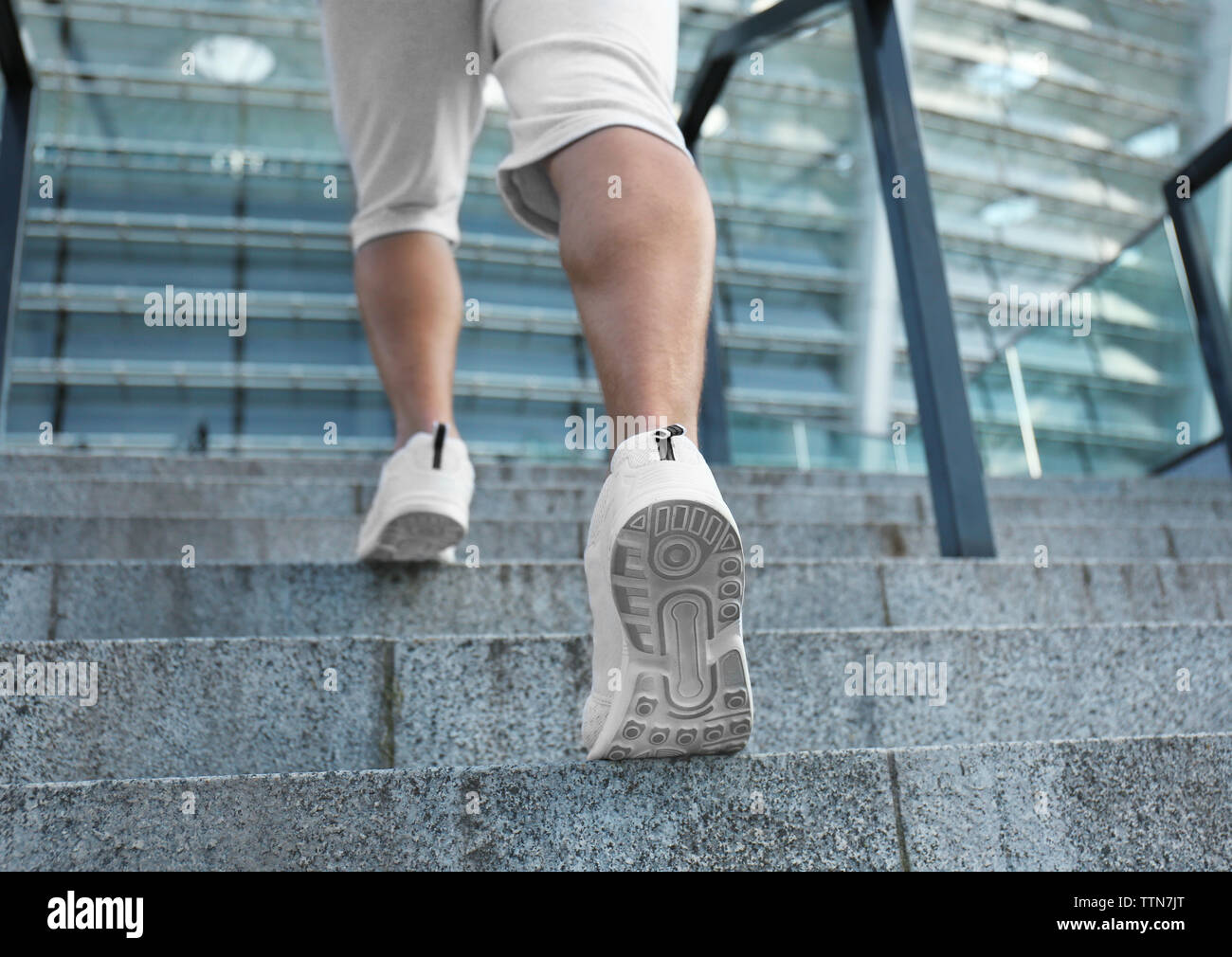 Young man running on stairs Stock Photo - Alamy