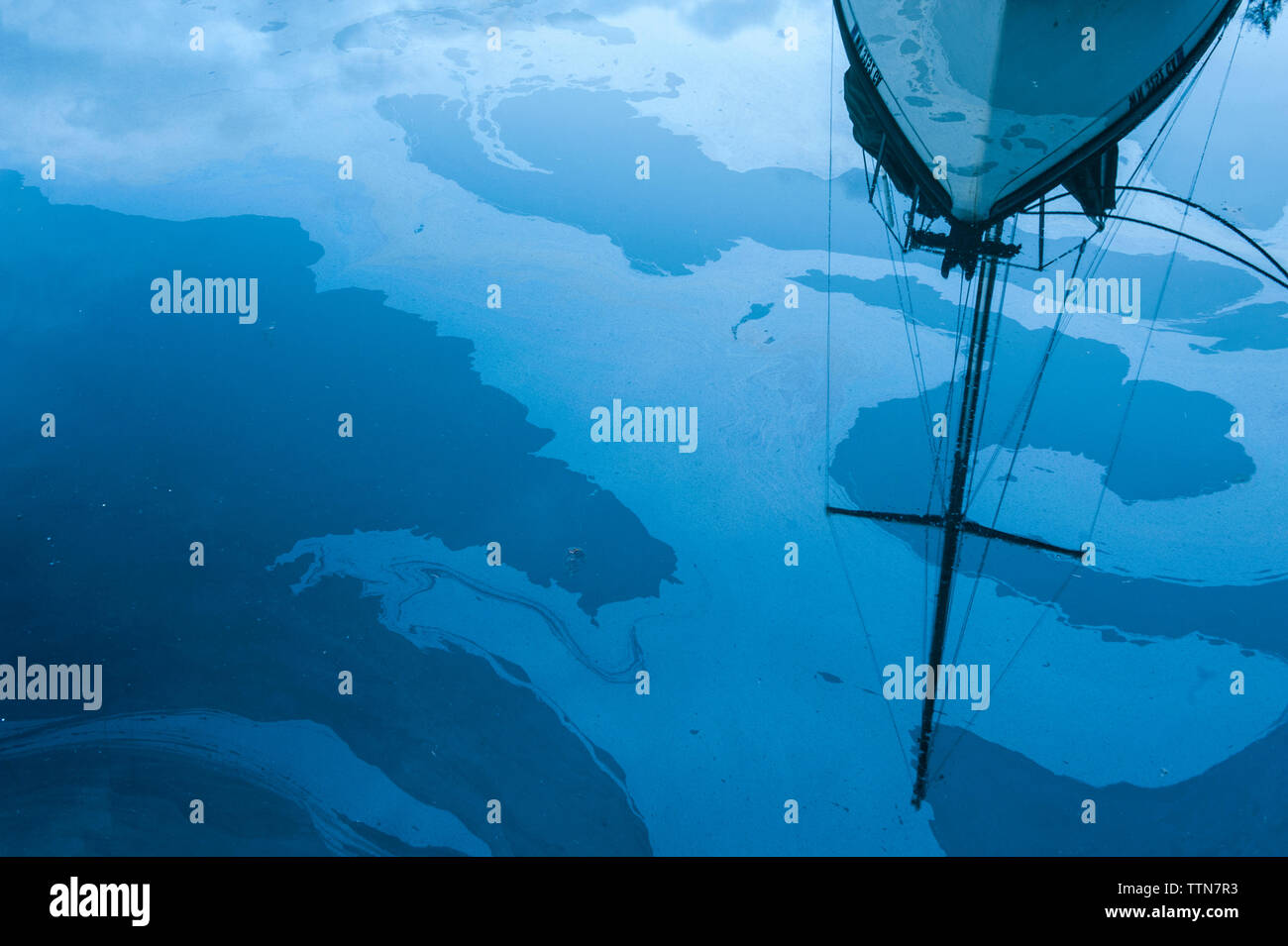 High angle view of boat mast reflecting on sea Stock Photo - Alamy
