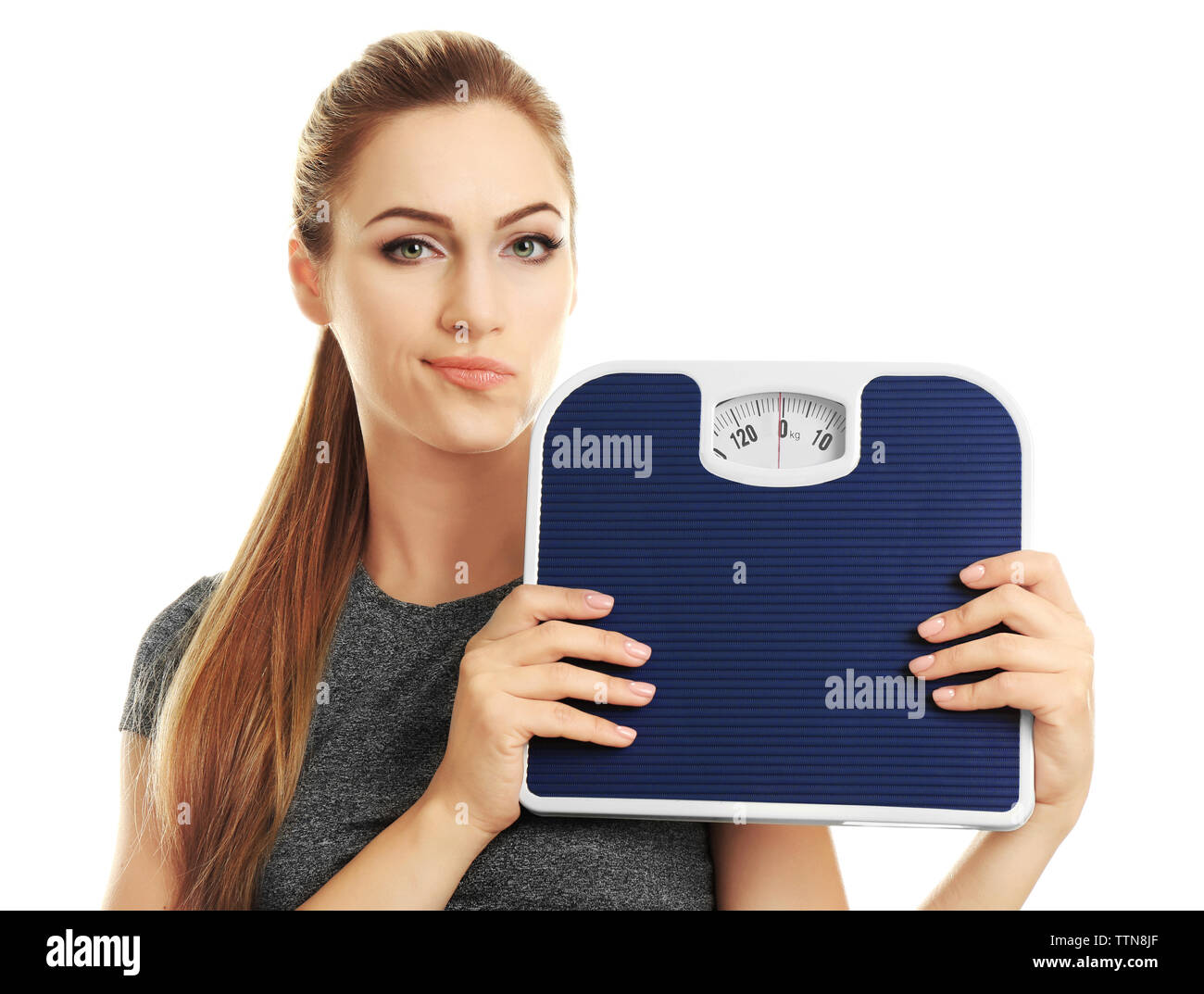 Beautiful young woman holding floor scales on white background Stock ...