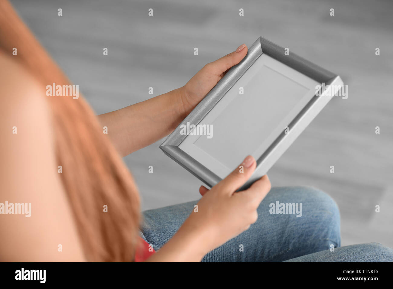 Female hands holding photo frame on light background Stock Photo - Alamy