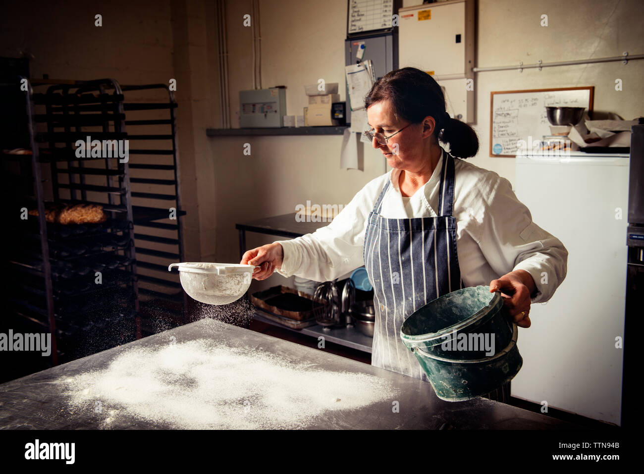Baker spreading flour hi-res stock photography and images - Alamy