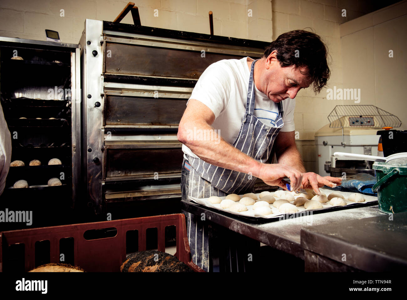 Baker working with raw dough hi-res stock photography and images - Alamy