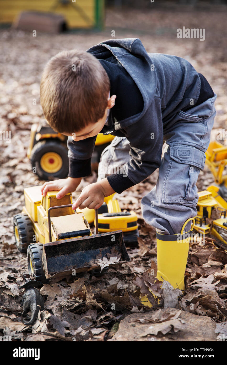 Boy playing with toys outdoors Stock Photo - Alamy