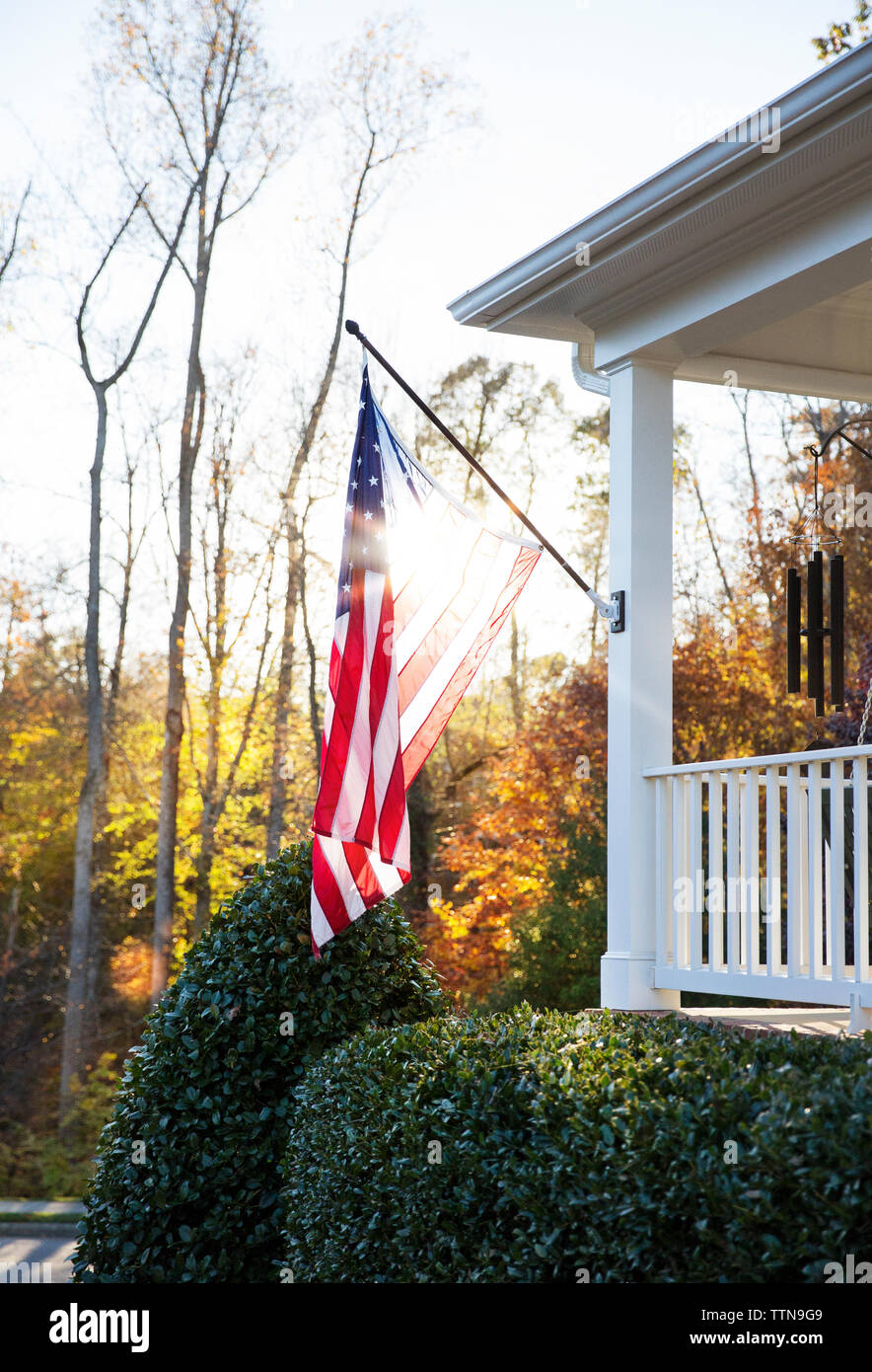 American flag hanging in front of house Stock Photo - Alamy