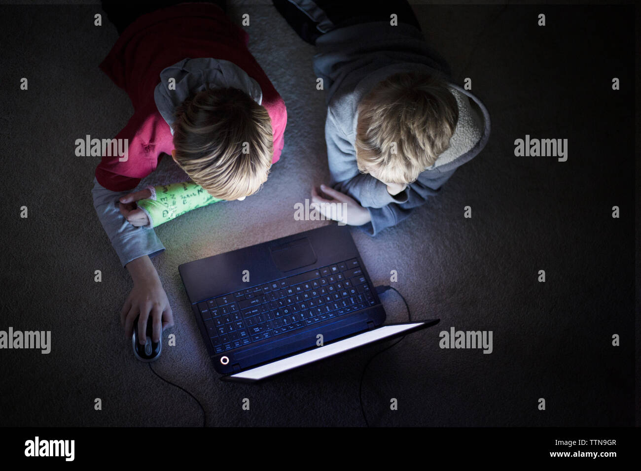 Two boys using laptop Stock Photo - Alamy