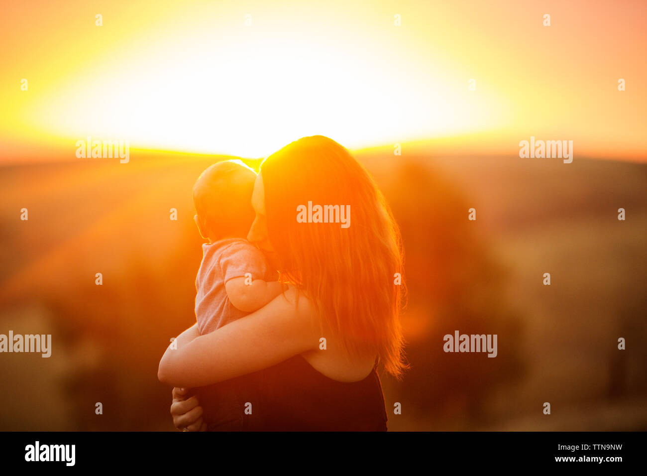 Baby with sunset hi-res stock photography and images - Alamy