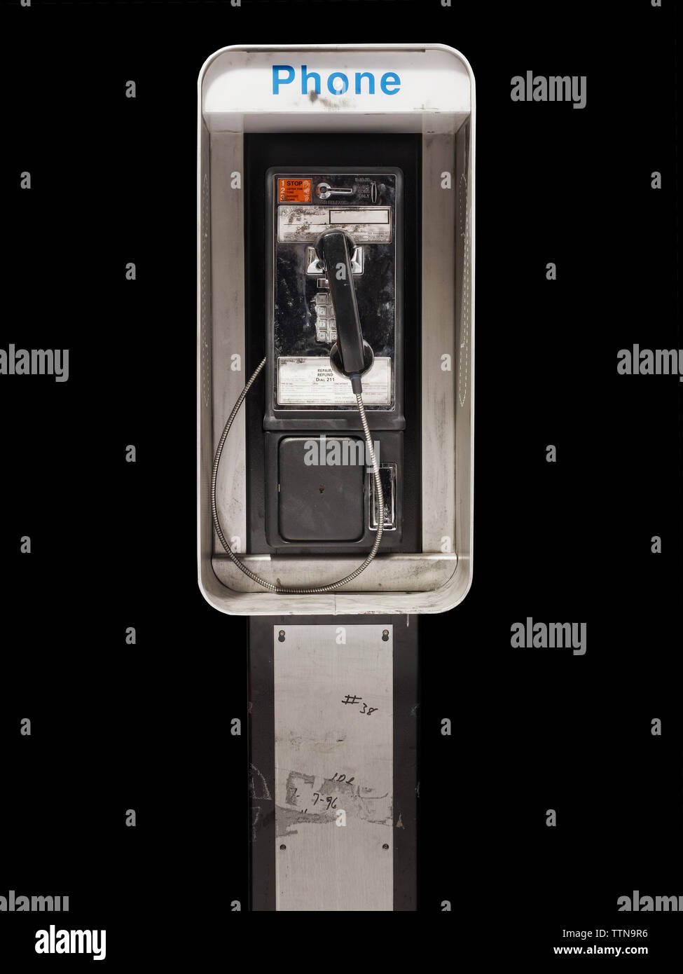 Pay phone on black background Stock Photo - Alamy
