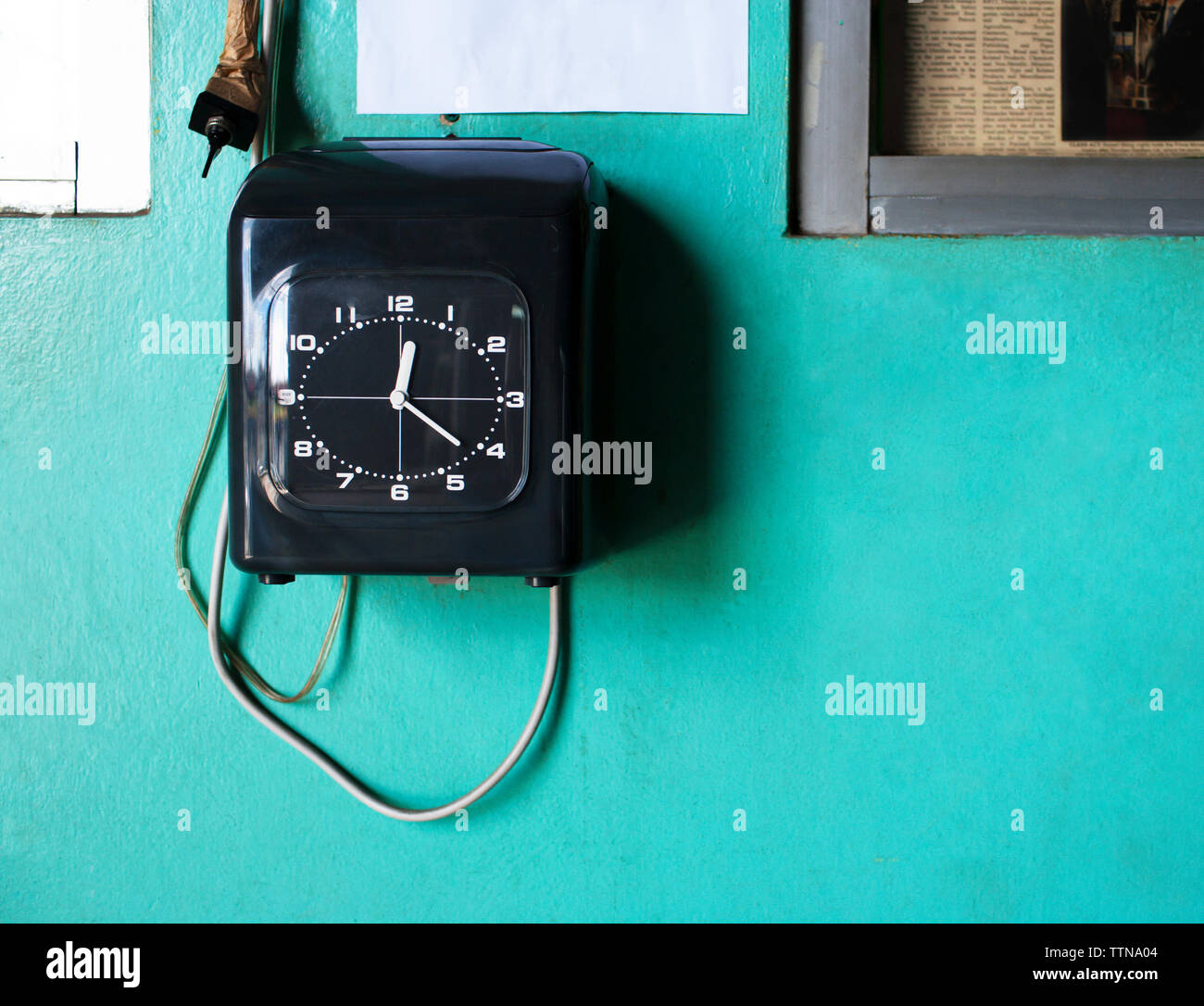 Phone with clock on wall Stock Photo - Alamy