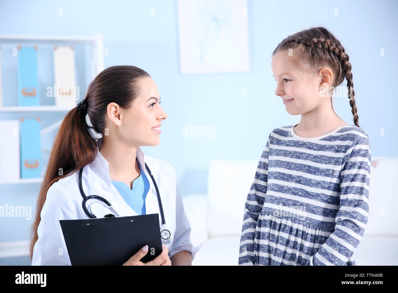 Cute girl visiting a doctor Stock Photo - Alamy