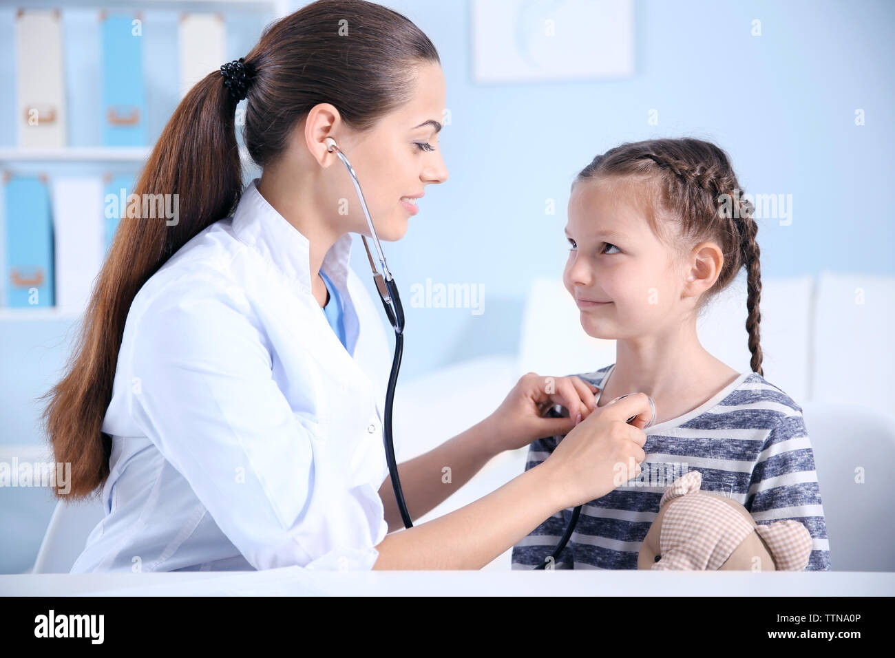 Cute girl visiting a doctor Stock Photo - Alamy