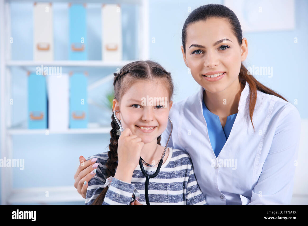 Cute girl visiting a doctor Stock Photo - Alamy