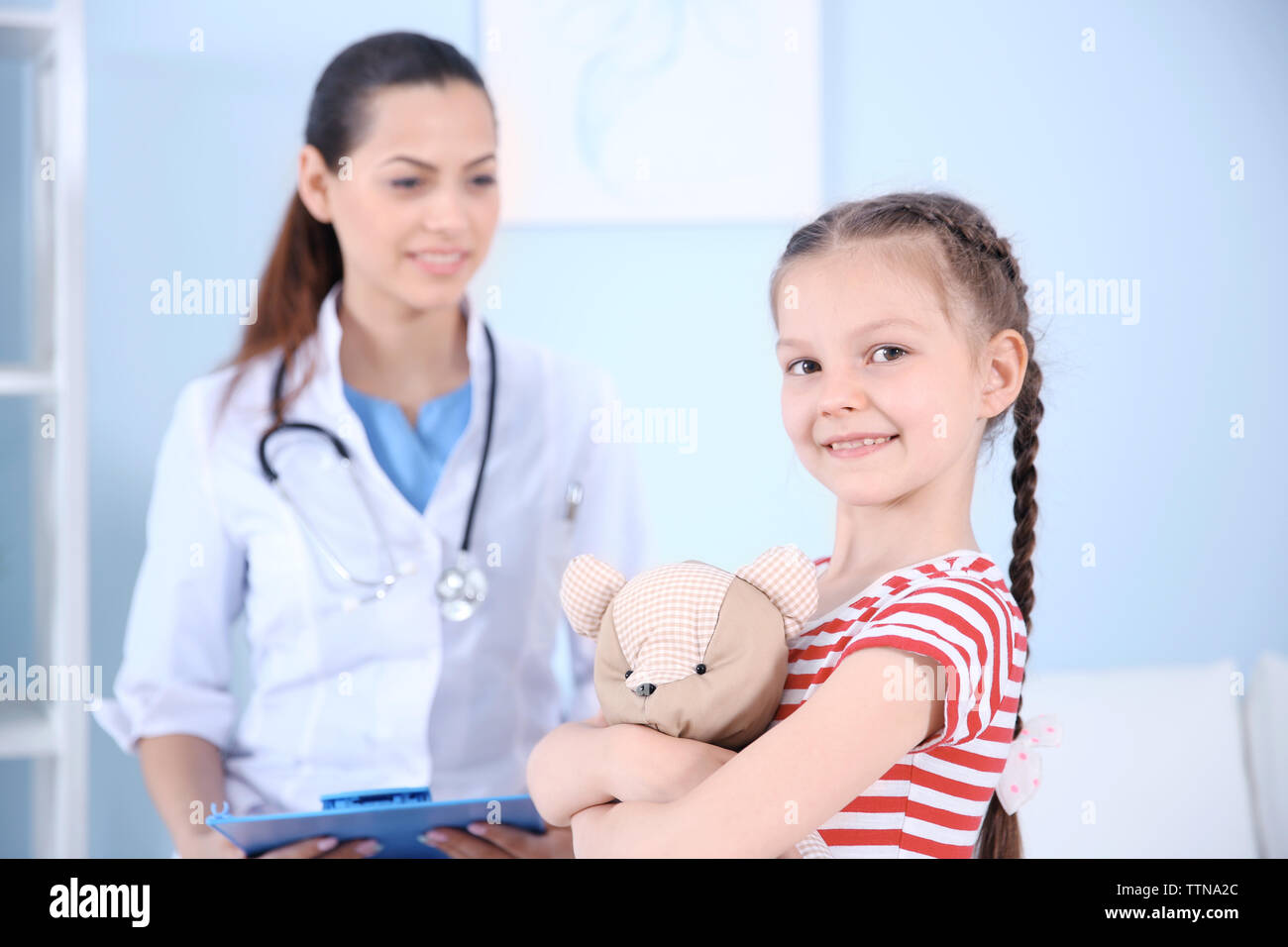 Cute girl visiting a doctor Stock Photo - Alamy