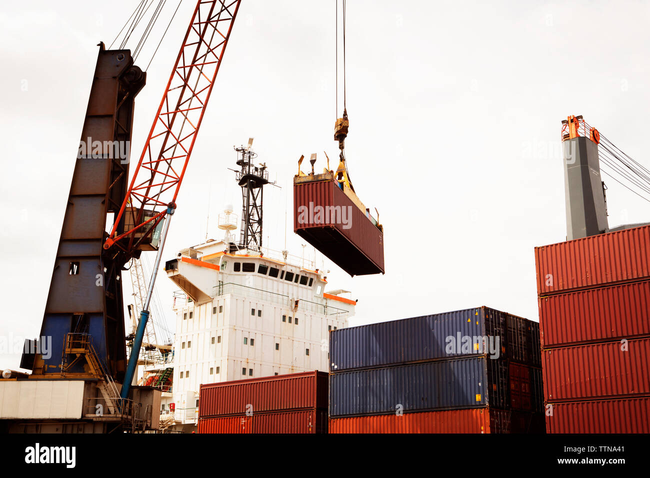 View of crane loading container Stock Photo - Alamy