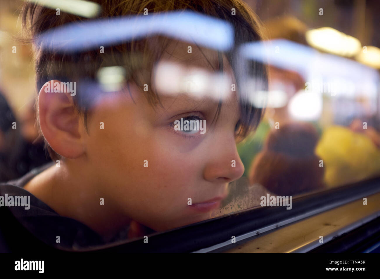 Boy looking through window hi-res stock photography and images - Alamy